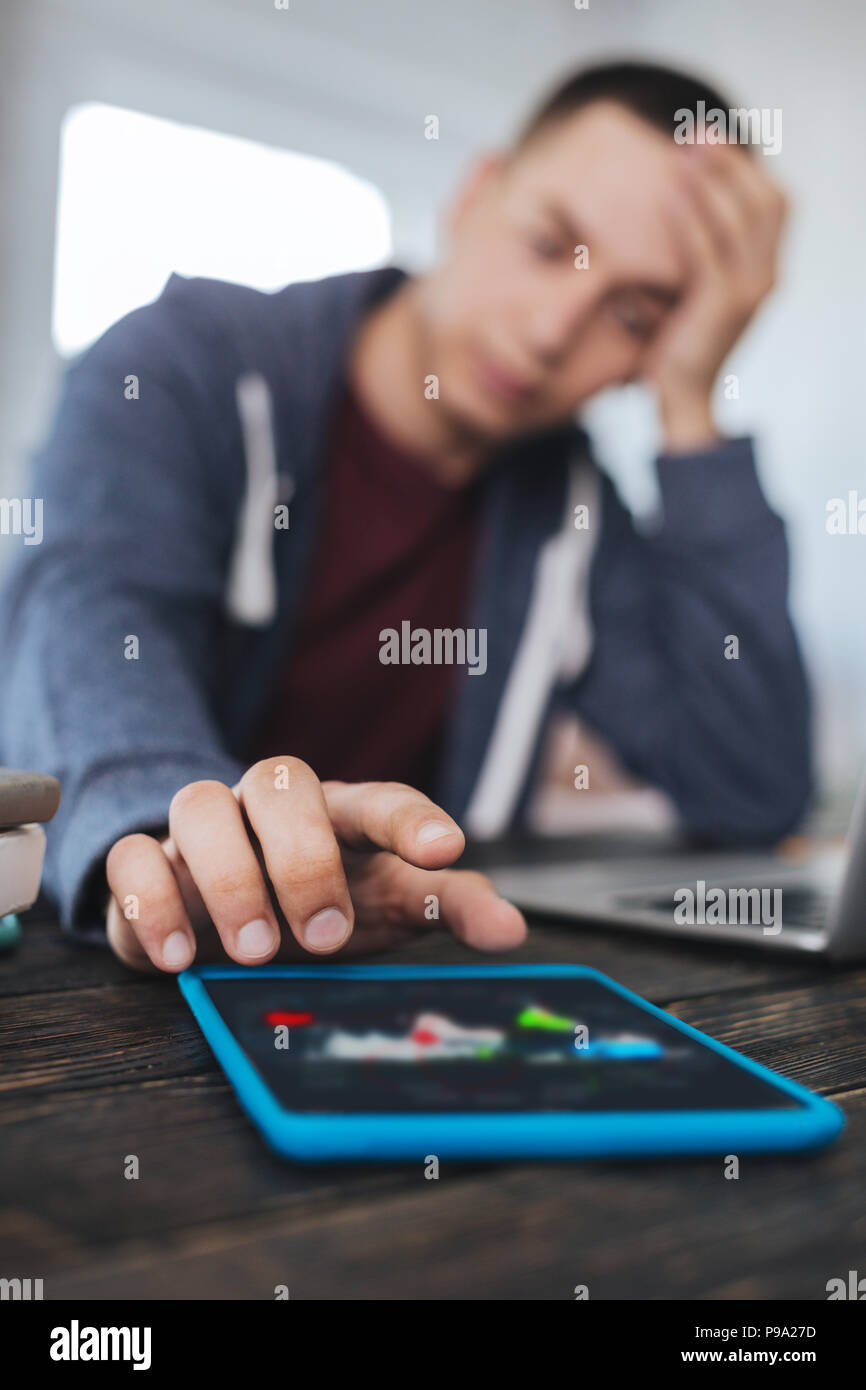 Sad man touching his phone Stock Photo - Alamy