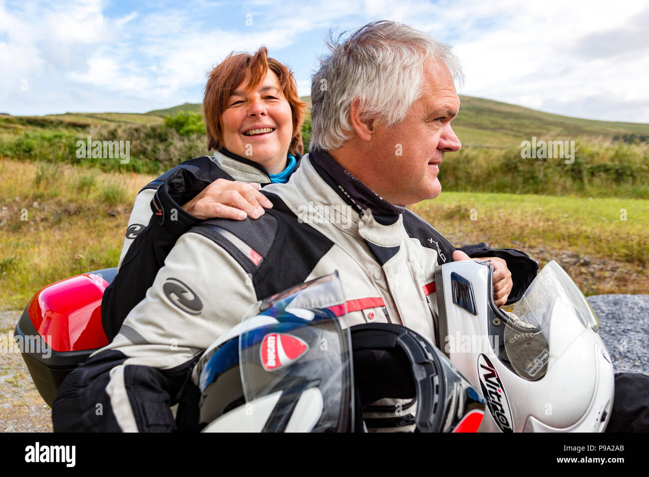 Older couple riding powerful motorbike, Ducati Multistrada 1200 Stock ...