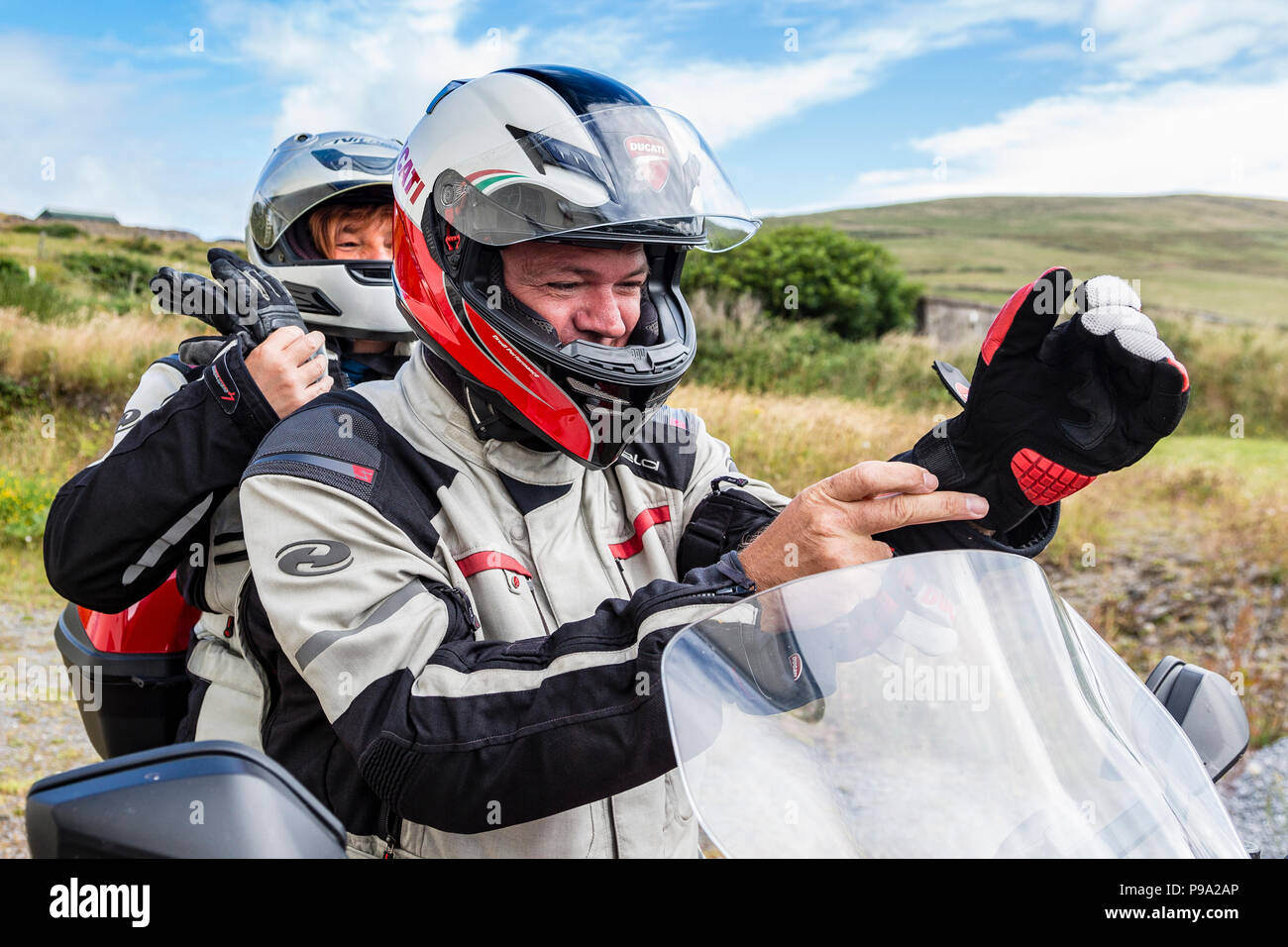 Older couple riding powerful motorbike, Ducati Multistrada 1200 Stock ...