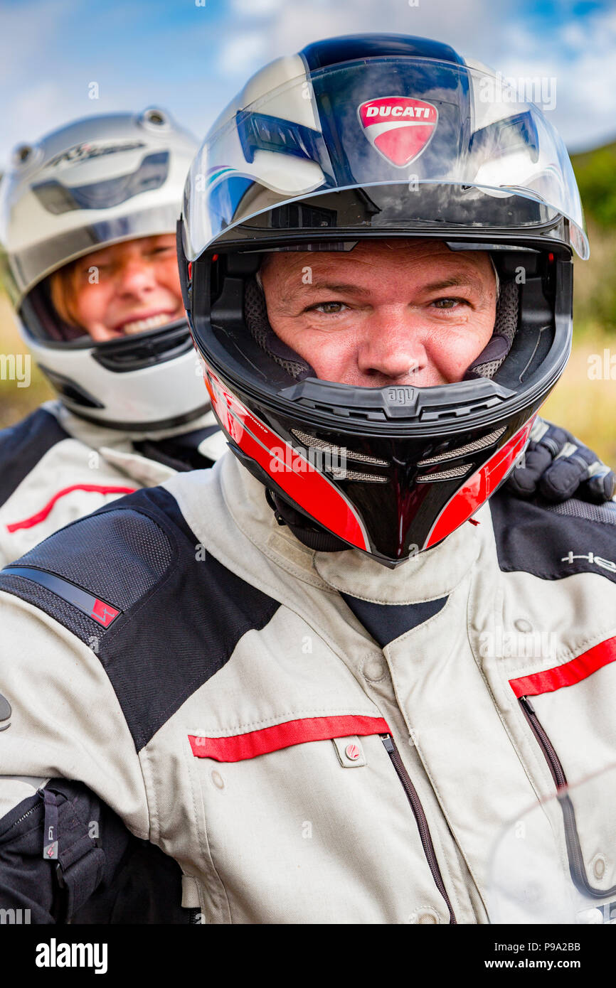 Older couple riding powerful motorbike, Ducati Multistrada 1200 Stock ...
