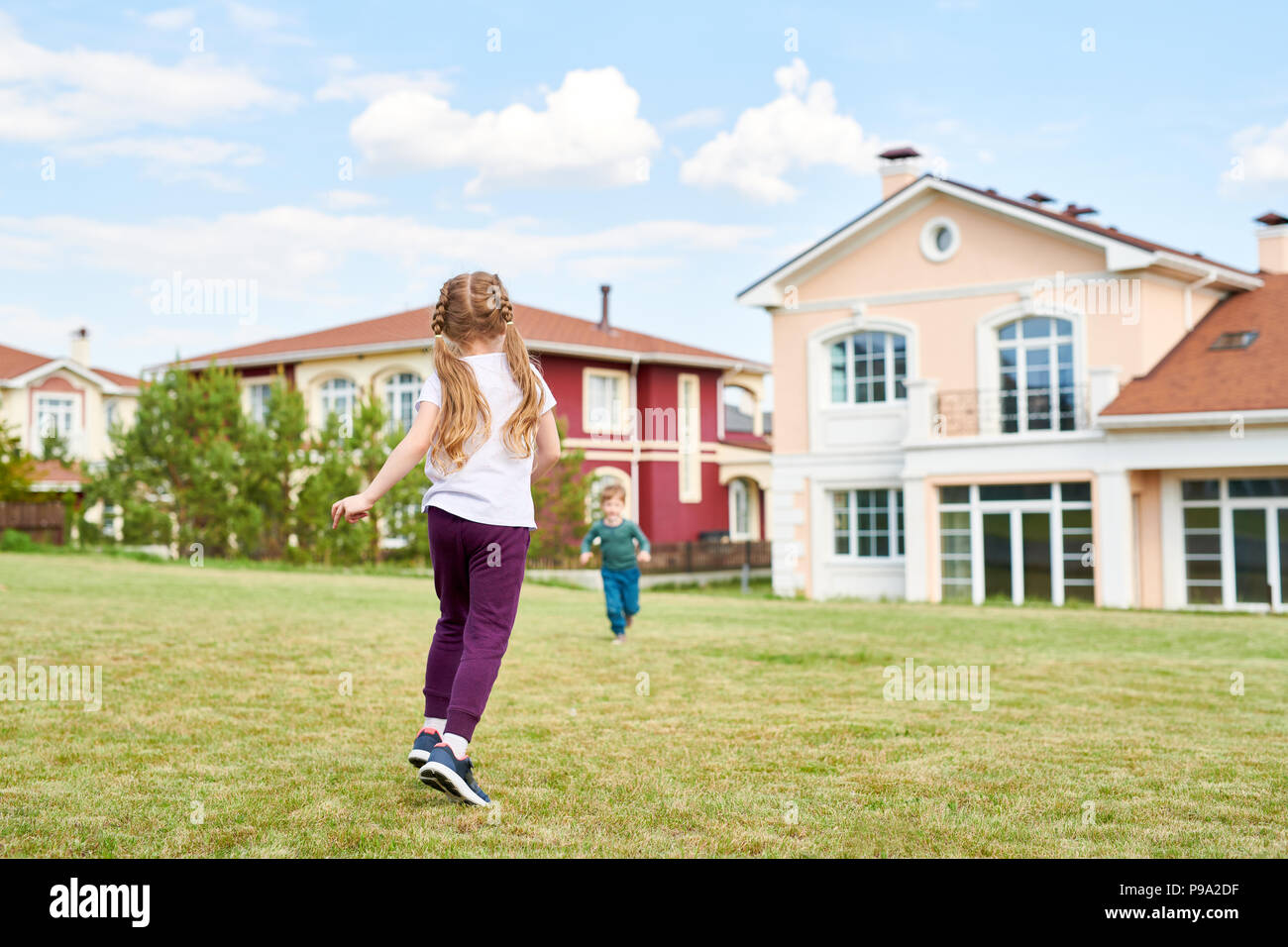 Two of Children Playing in Front Yard Stock Photo - Alamy
