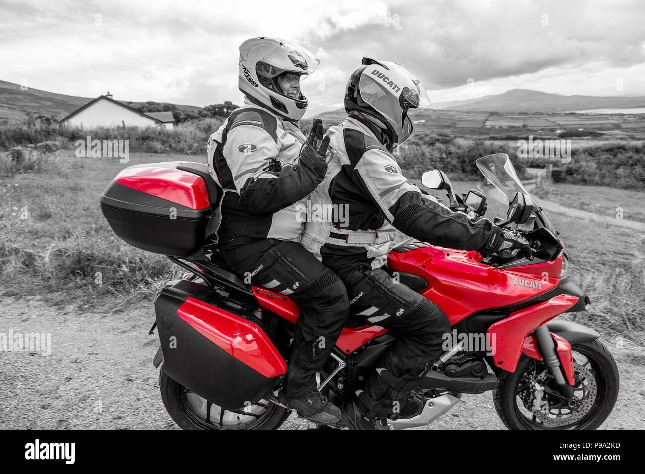 Older couple riding powerful motorbike, Ducati Multistrada 1200 Stock ...