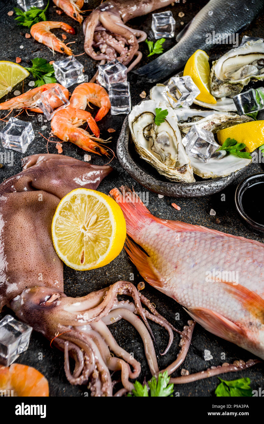Fresh raw seafood squid shrimp oyster mussels fish with spices of herbs ...