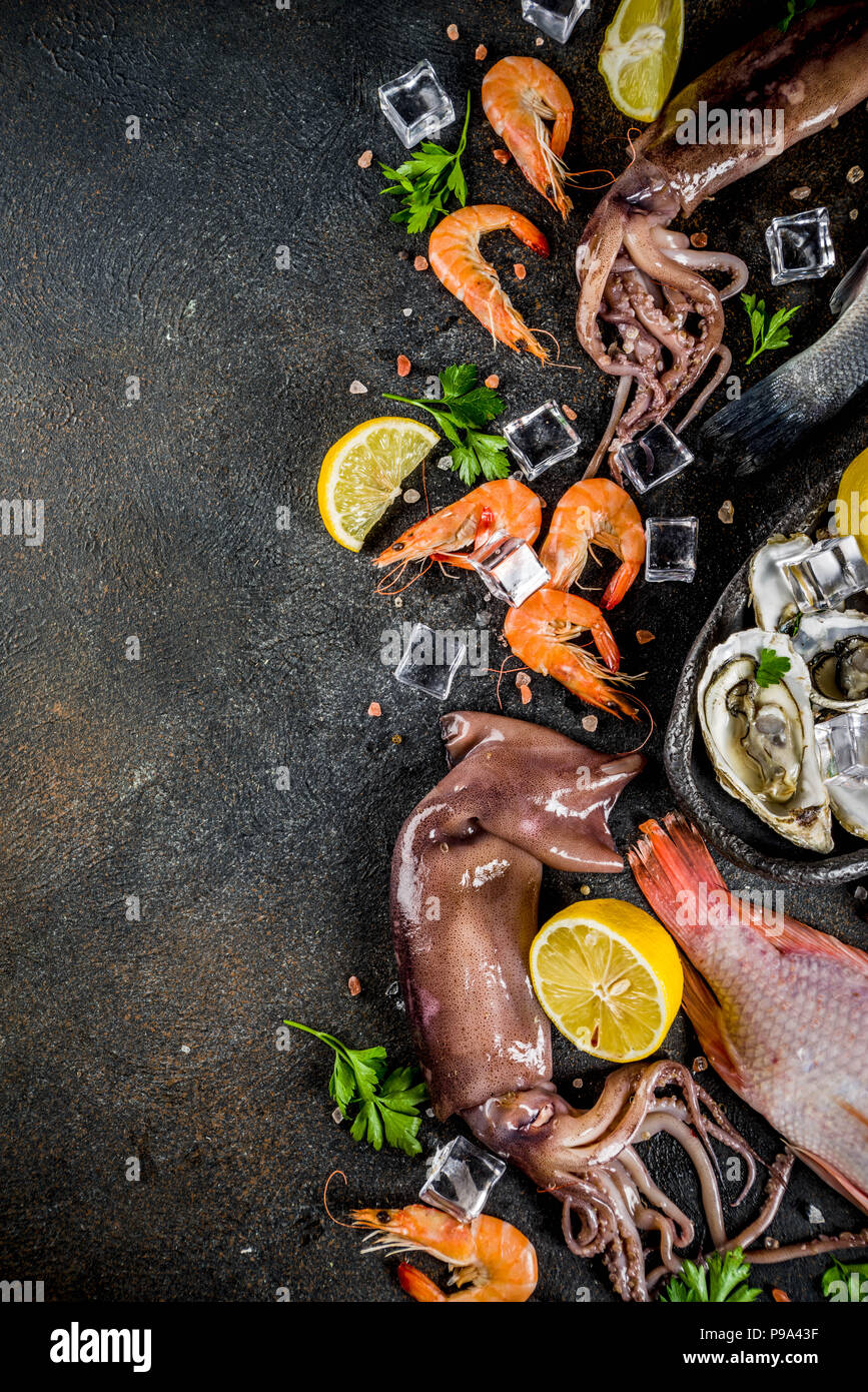 Fresh raw seafood squid shrimp oyster mussels fish with spices of herbs ...