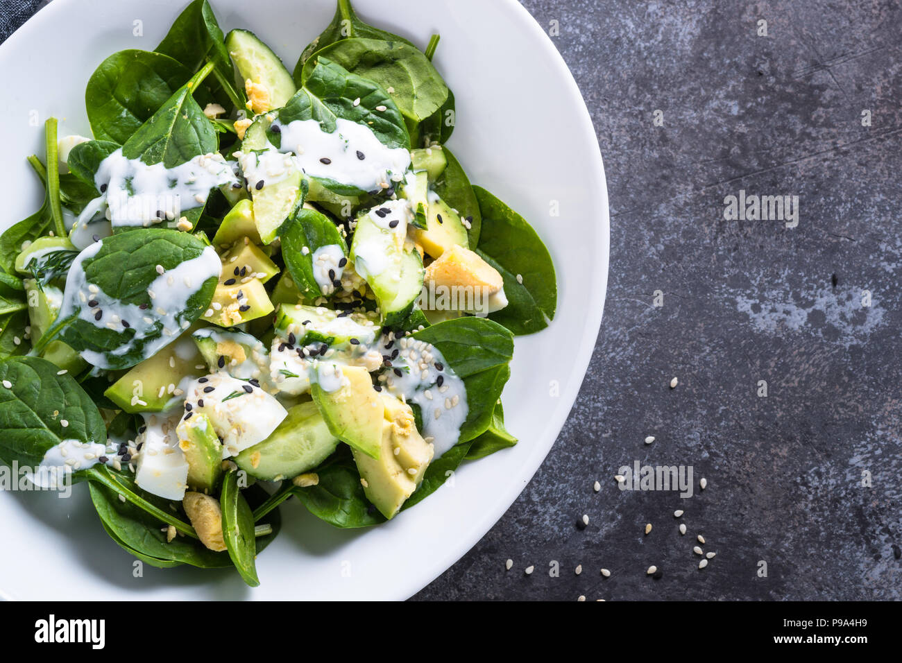 Green salad. Fresh salad from spinach, avocado, eggs and cucumber with ...
