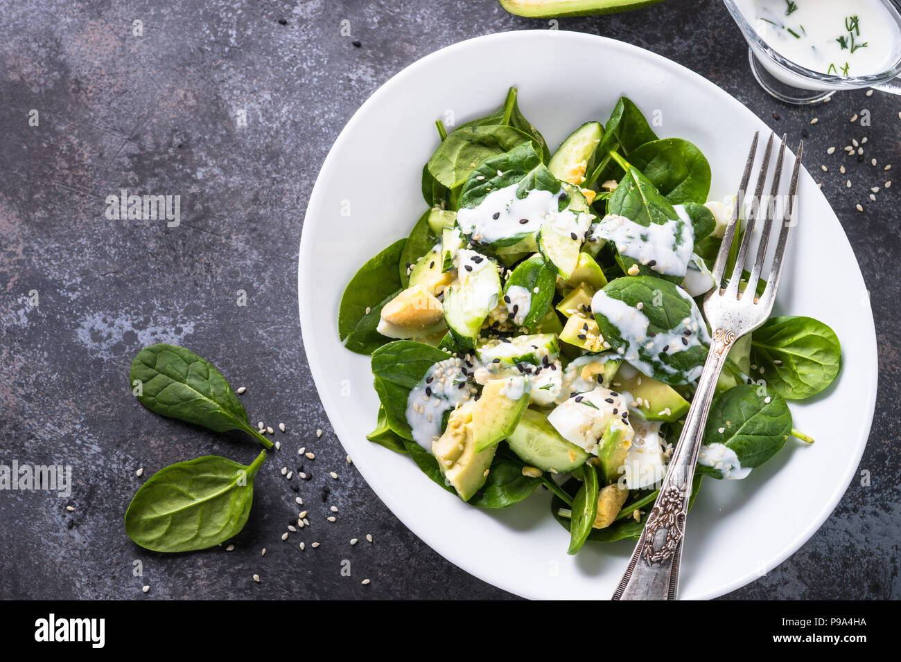 Green salad. Fresh salad from spinach, avocado, eggs and cucumber with ...