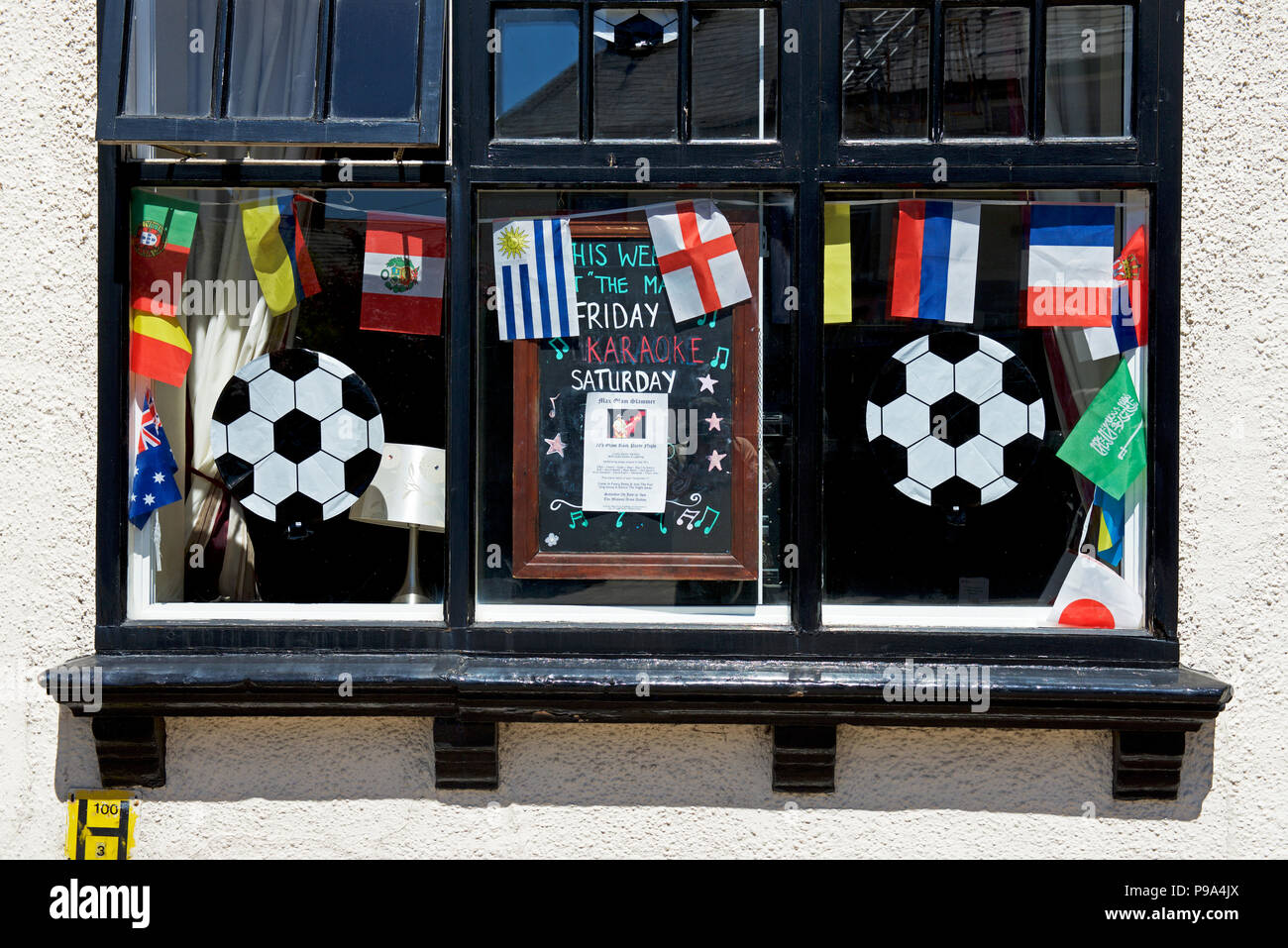 Football-themed window of pub, England UK Stock Photo - Alamy