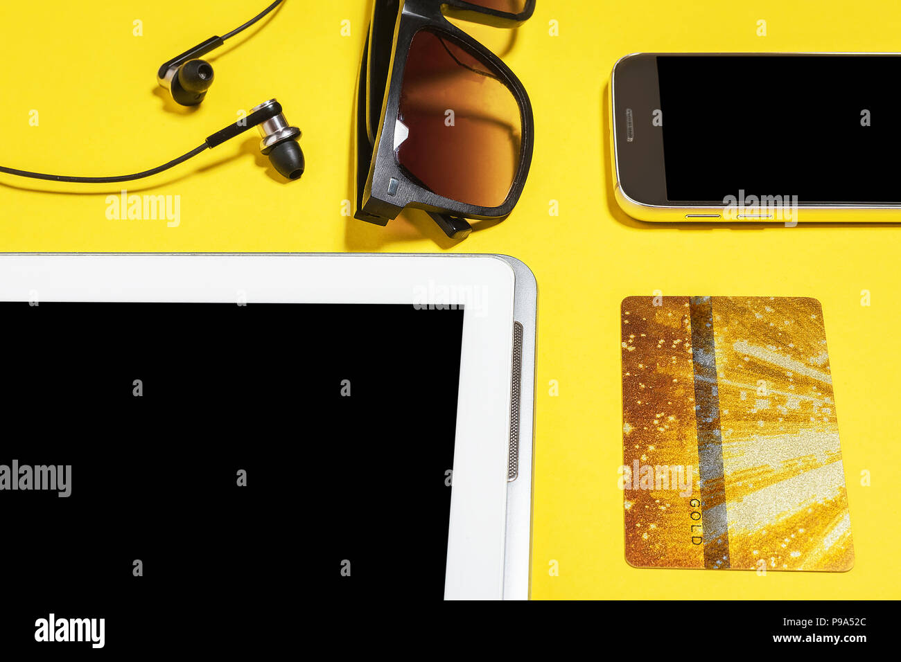 electronic devices and accessories on a yellow background Stock Photo ...