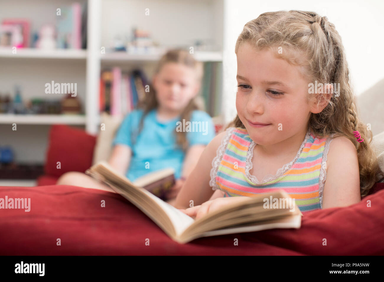 Two girls reading book hi-res stock photography and images - Alamy