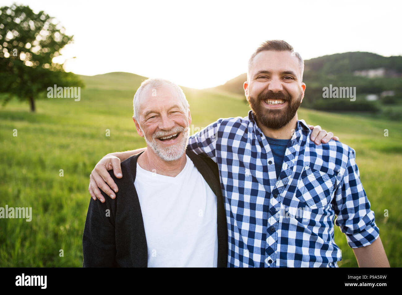A Portrait Of An Adult Hipster Son With Senior Father In Nature At