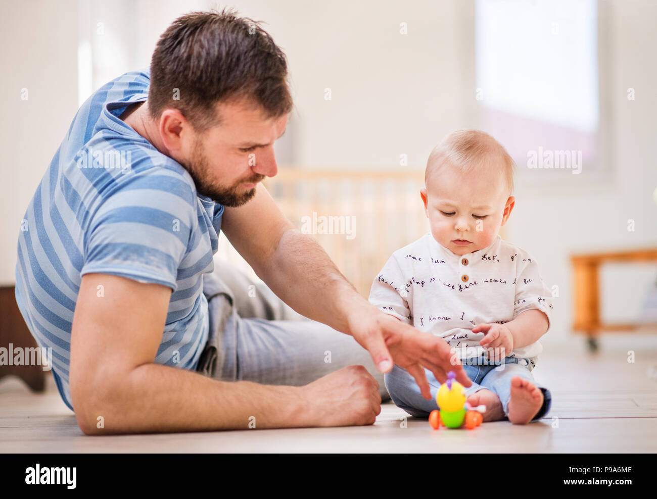 Father and infant playing with toy hi-res stock photography and images ...