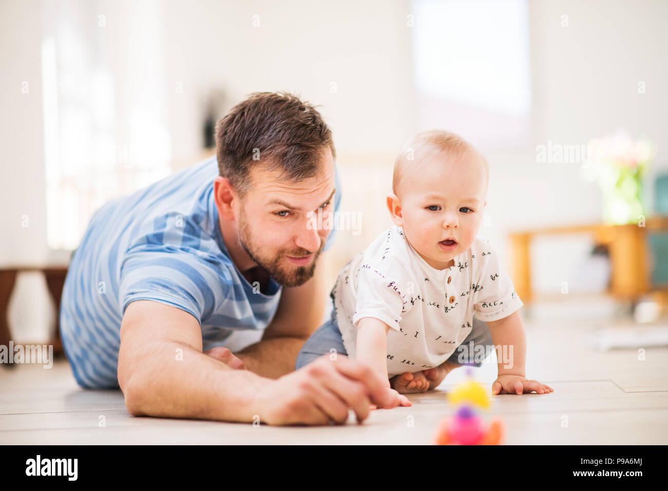 Father and infant playing with toy hi-res stock photography and images ...