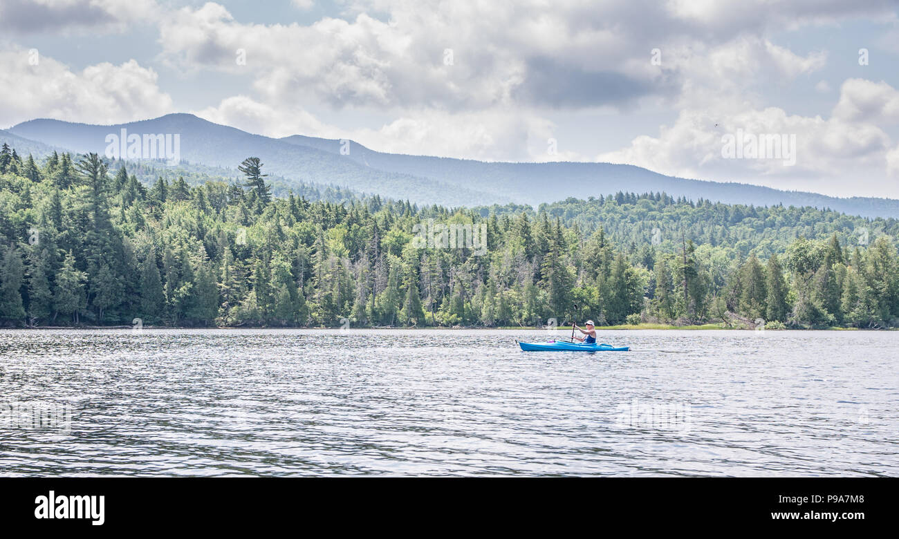 Female kayaker on a remote pond in the Adirondack wilderness Stock ...