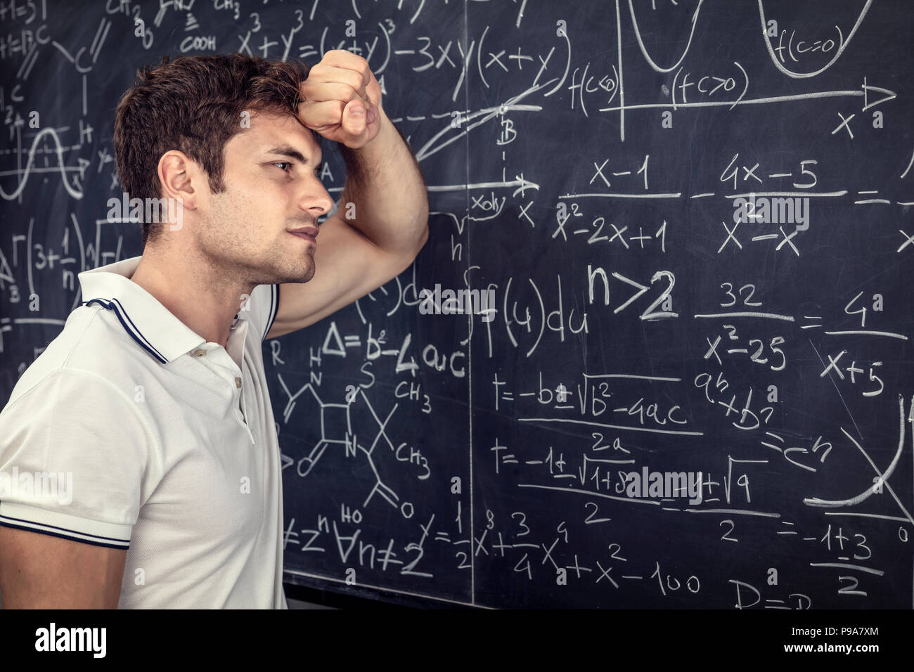 very tired student look blackboard Stock Photo - Alamy