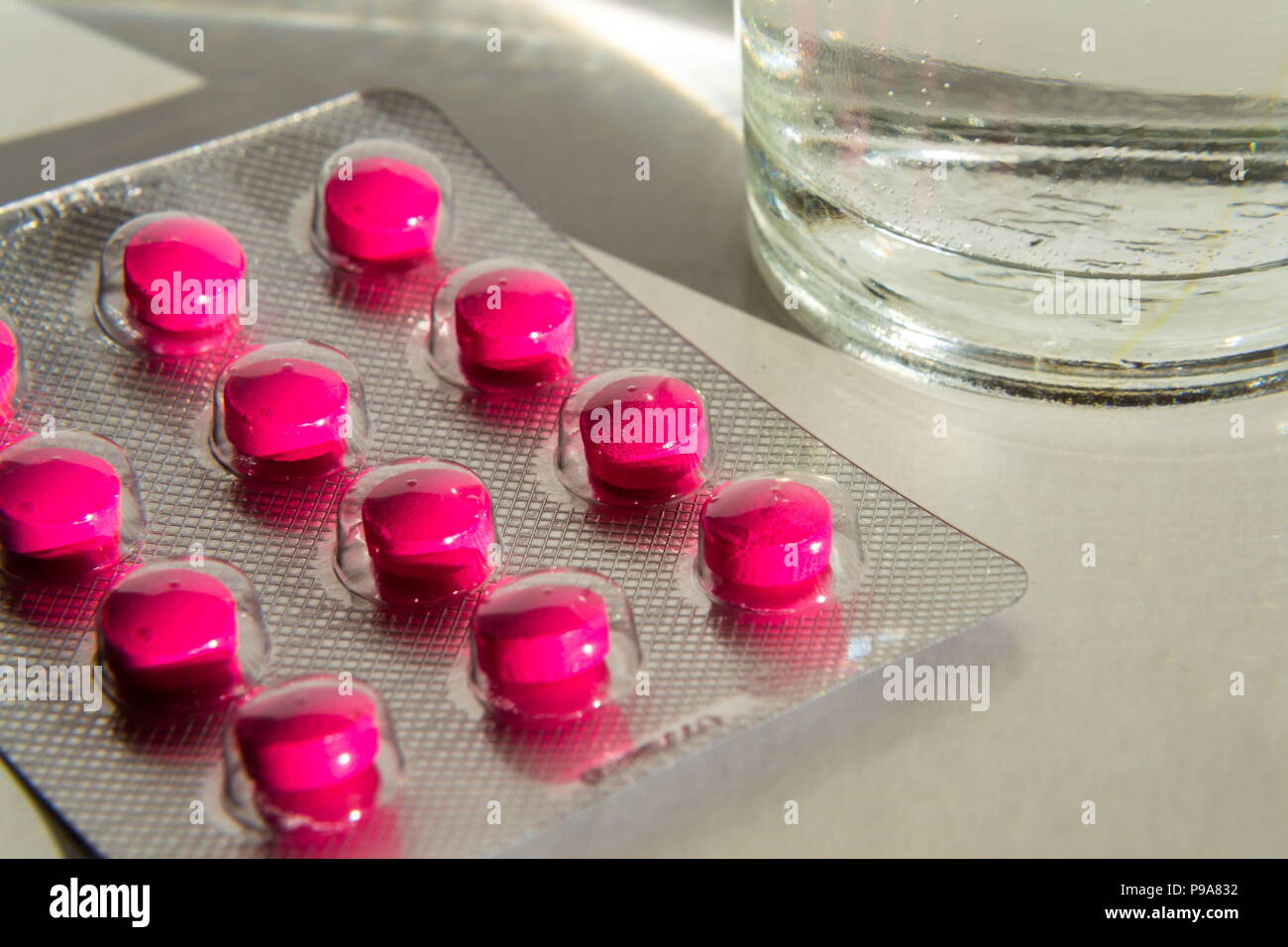 Pink ibuprofen pills on white hi-res stock photography and images - Alamy