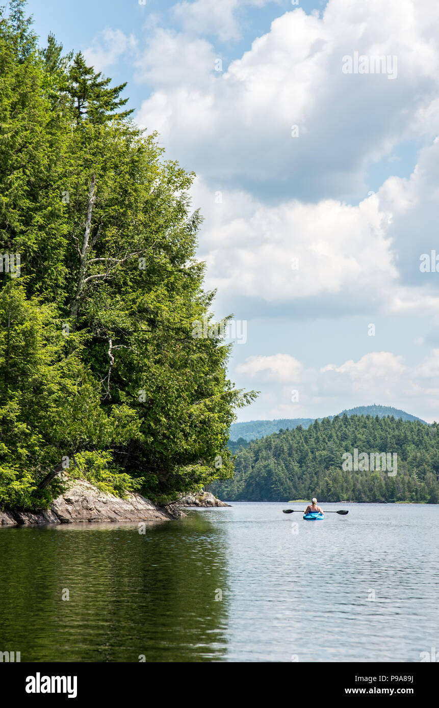 Female kayaker on a remote pond in the Adirondack wilderness Stock ...