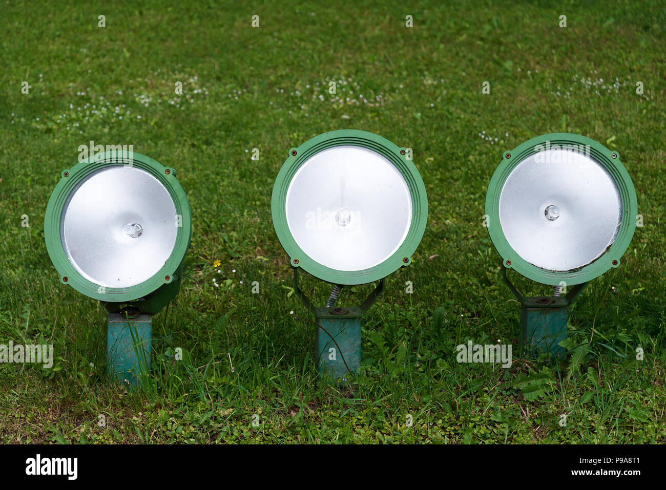 Three small spotlights on a green lawn in the Park Stock Photo - Alamy