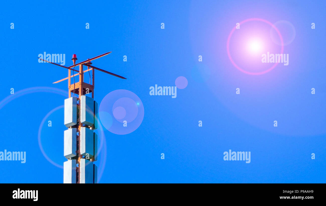 isolated comunication antenna under a blue sky with lens flare Stock ...