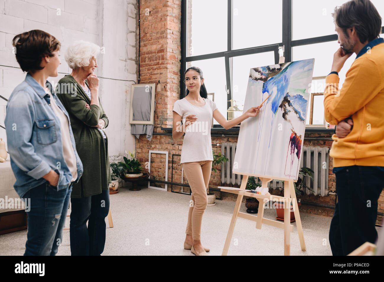 Full length portrait of pretty young woman presenting modern watercolor ...