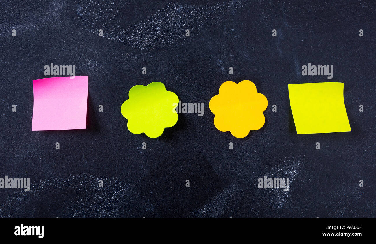 School concept. Sticky colorful notes in various shapes with copy space ...