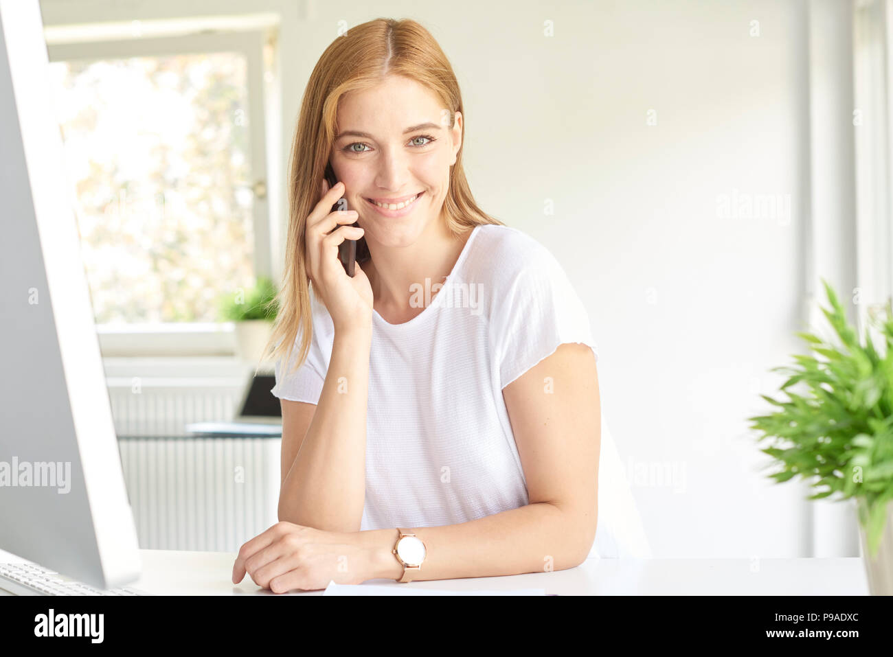 Beautiful young sales assistant businesswoman making call and doing ...