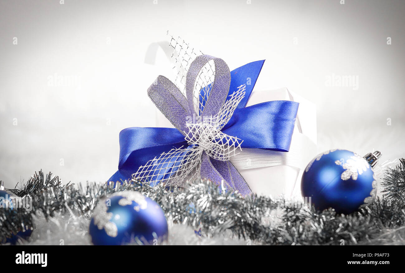Christmas gift and blue Christmas balls on a festive white back Stock ...