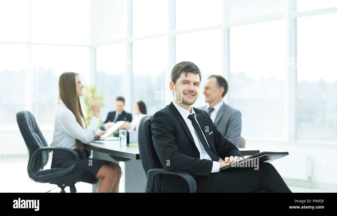 Serious boss sitting behind desk hi-res stock photography and images ...