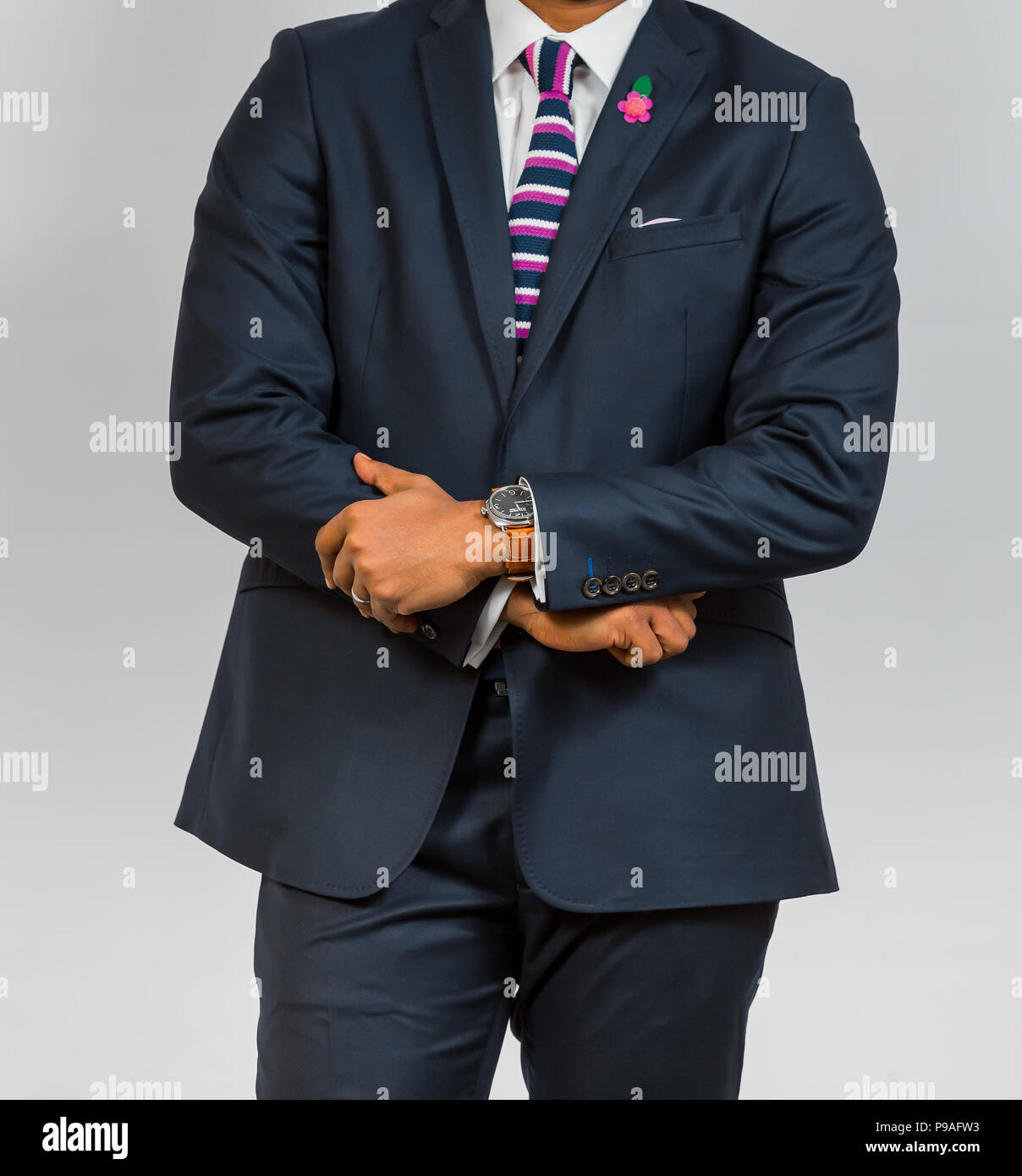 Young Man Suit Grey Arms Folded Stock Photos & Young Man Suit Grey Arms ...