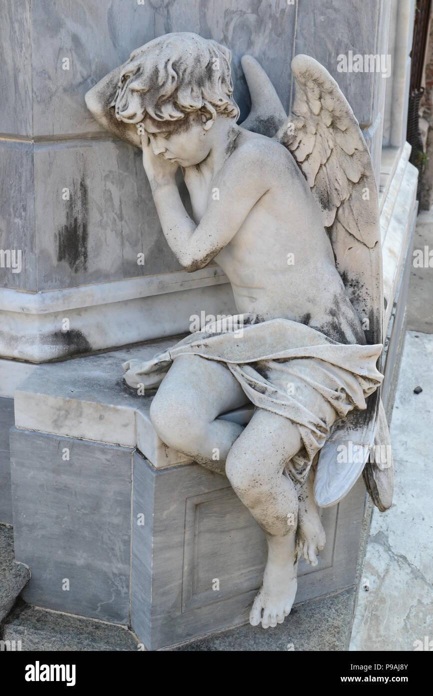 Boy Angel waiting by a crypt in La Recoleta cemetery in Buenos Aires ...