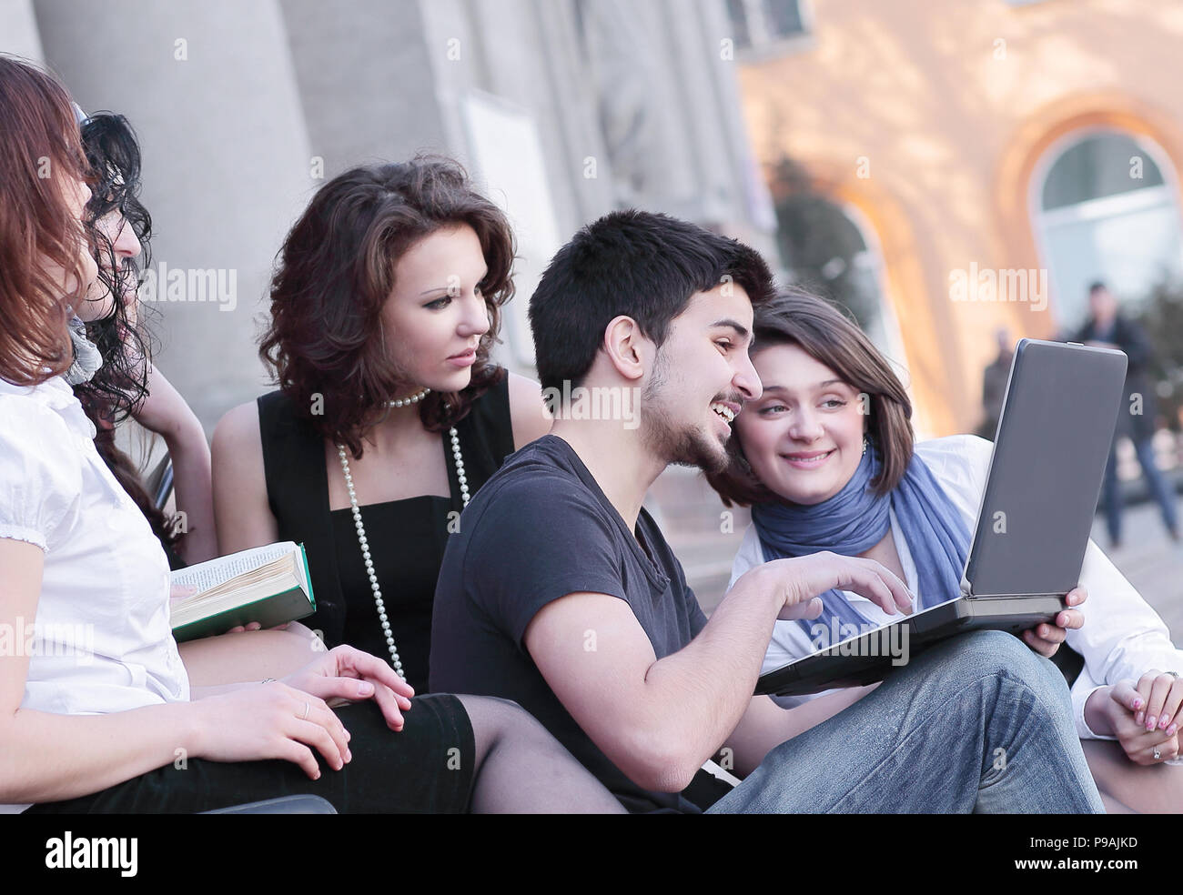 group of fellow students with books and laptop Stock Photo - Alamy