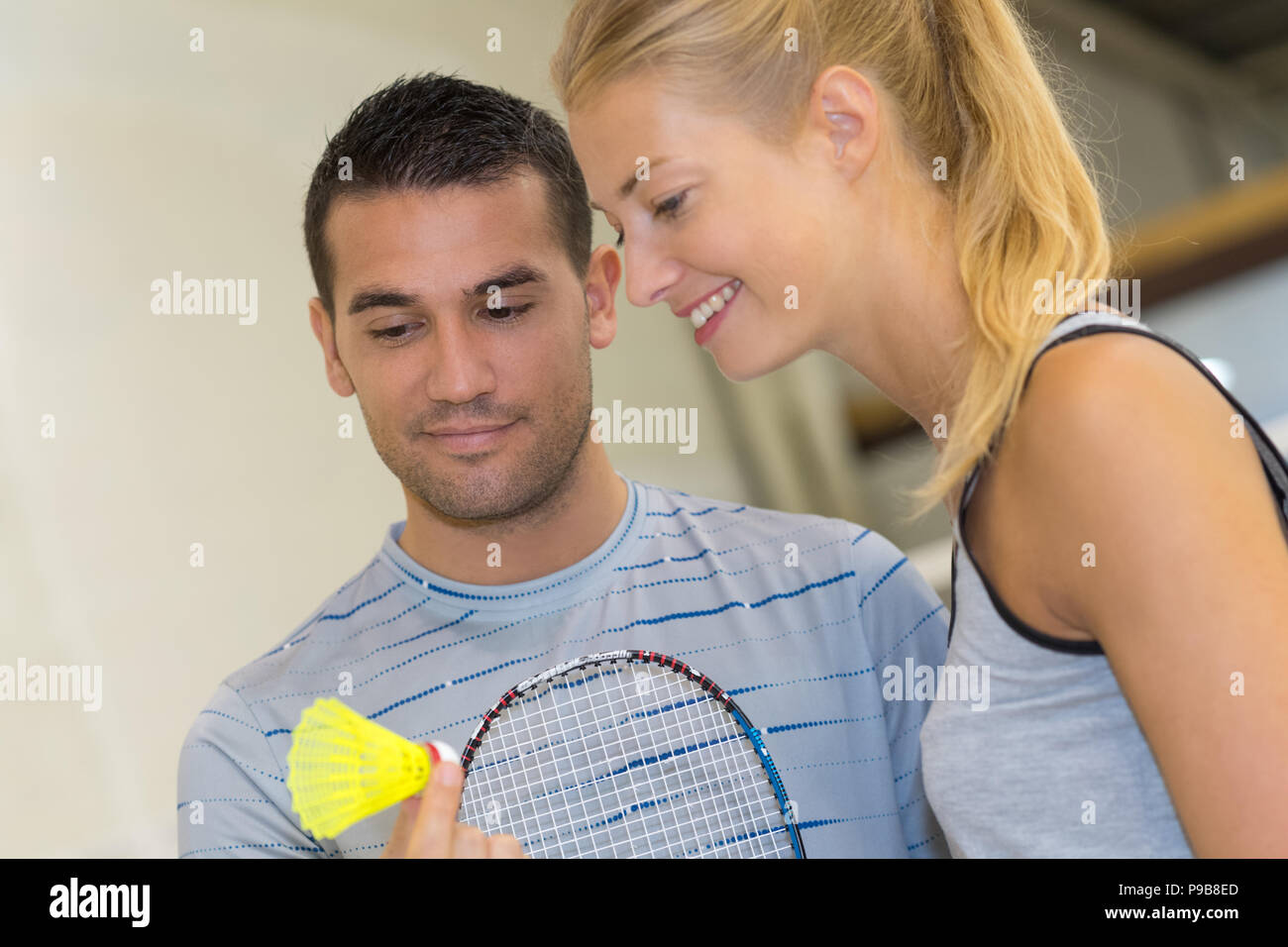 Couple with badminton equipment Stock Photo - Alamy