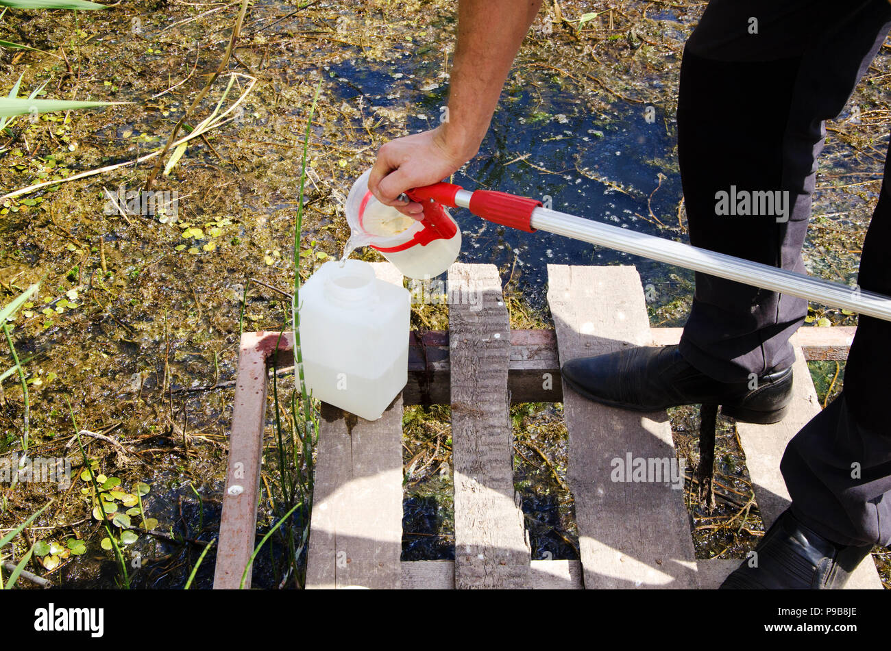 Take samples of water for laboratory testing. The concept - analysis of ...