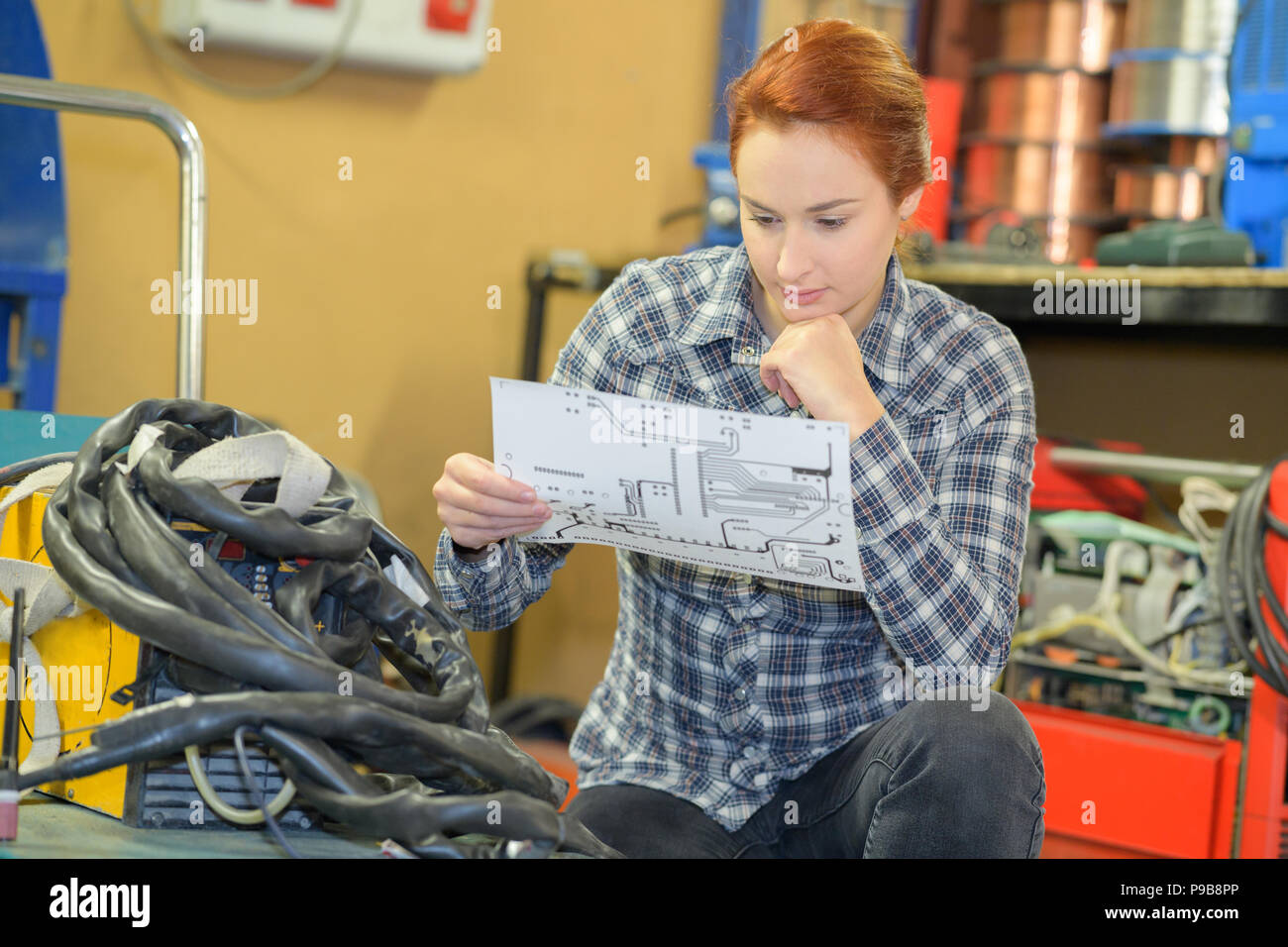 female worker checking clipboard in warehouse Stock Photo - Alamy