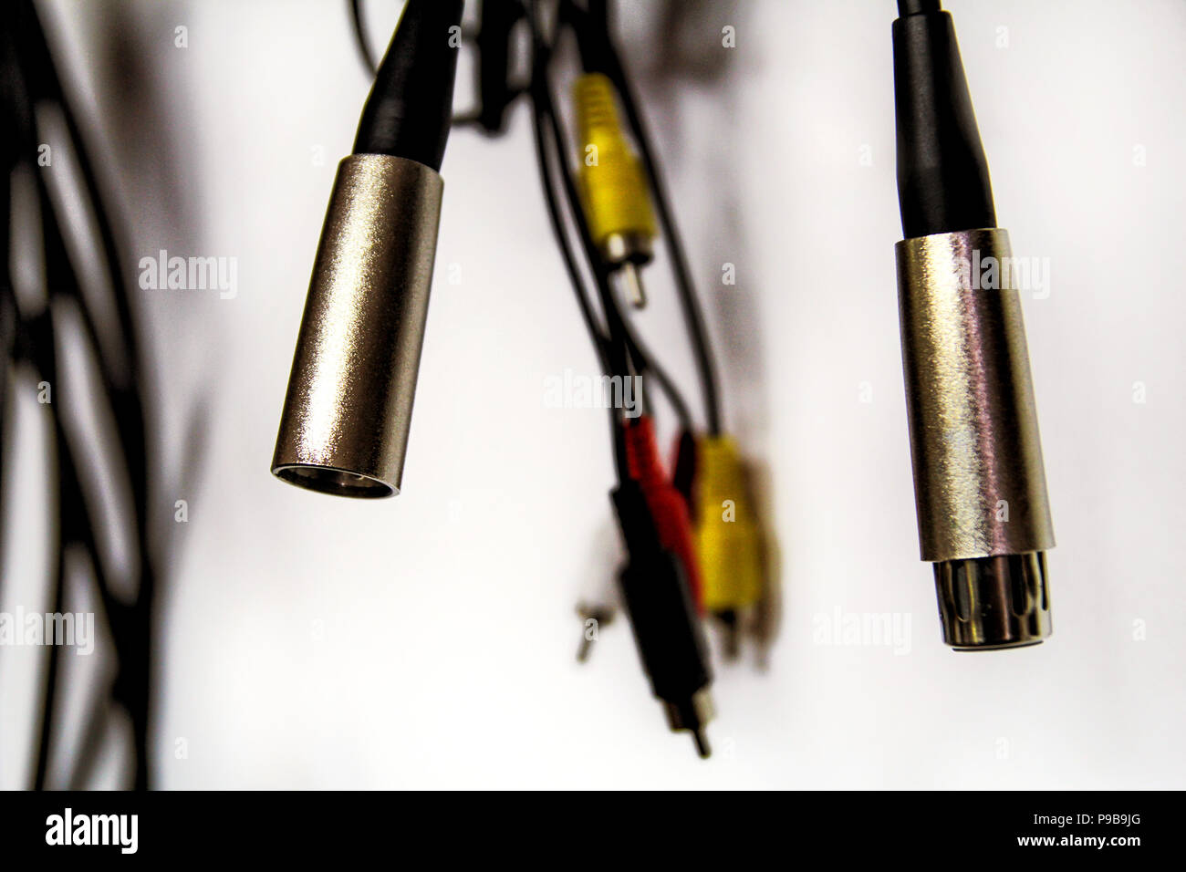 Music audio cables on a white background Stock Photo - Alamy