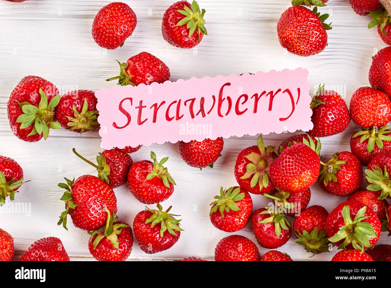 Fresh ripe strawberries background. Close up strawberries and pink ...