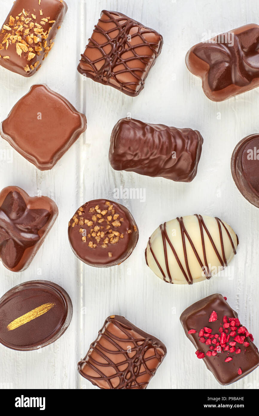 Assortment of chocolate candies on white background. Sweet background ...