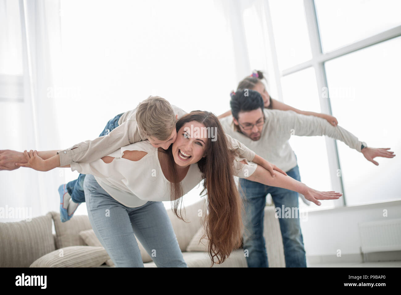 happy parents with their children have fun Stock Photo - Alamy