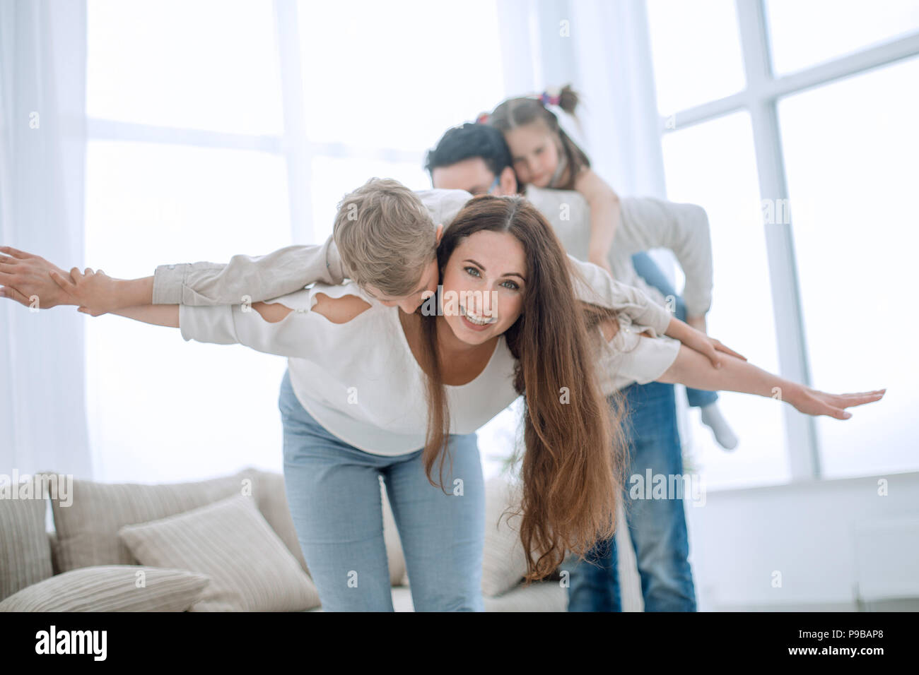 happy parents have fun with their children in the living room Stock ...