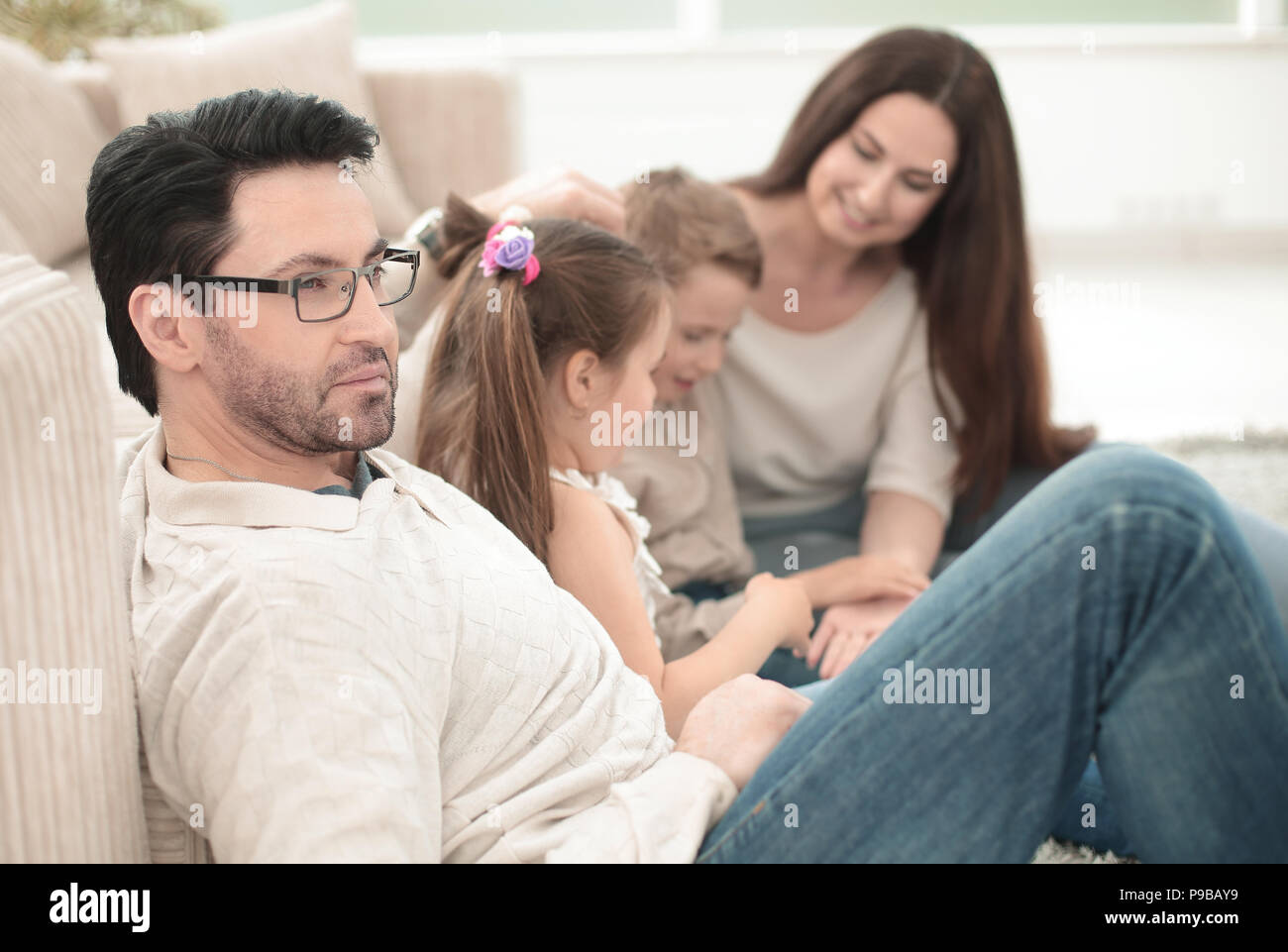 close up.parents play with their children sitting on the couch Stock ...