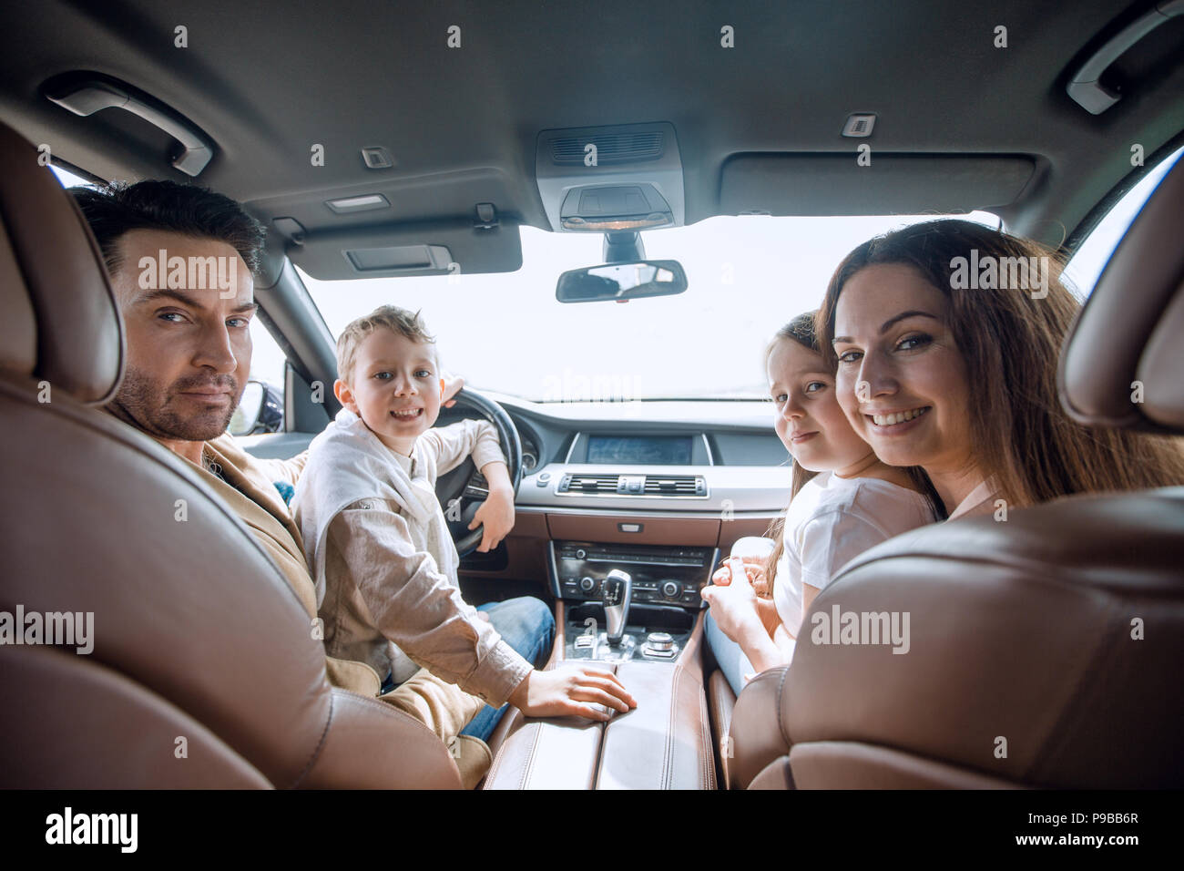 cheerful family sitting in the car Stock Photo - Alamy