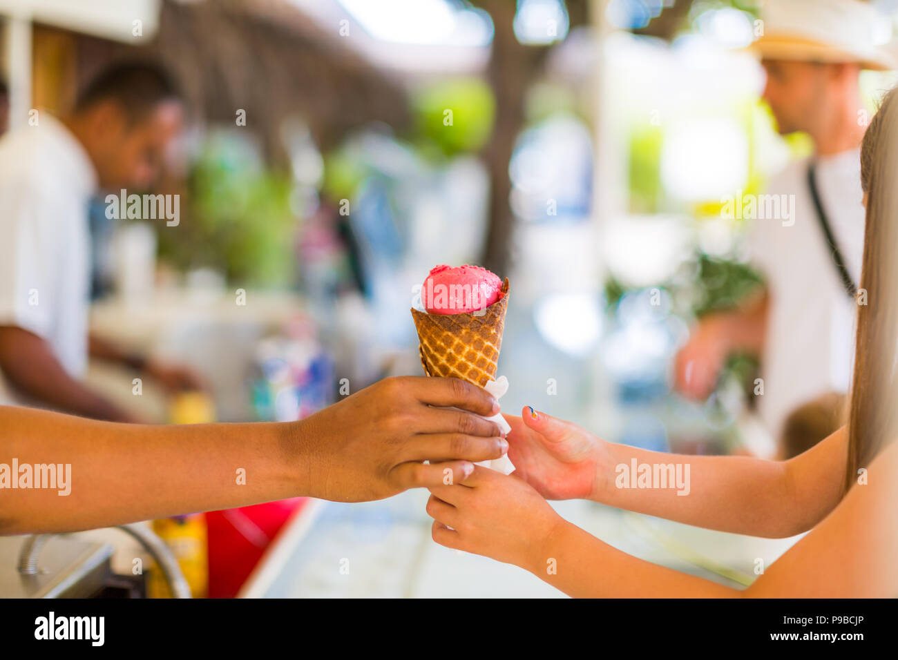 Handing over fresh ice cream to buyer. Summer beach mood with ...