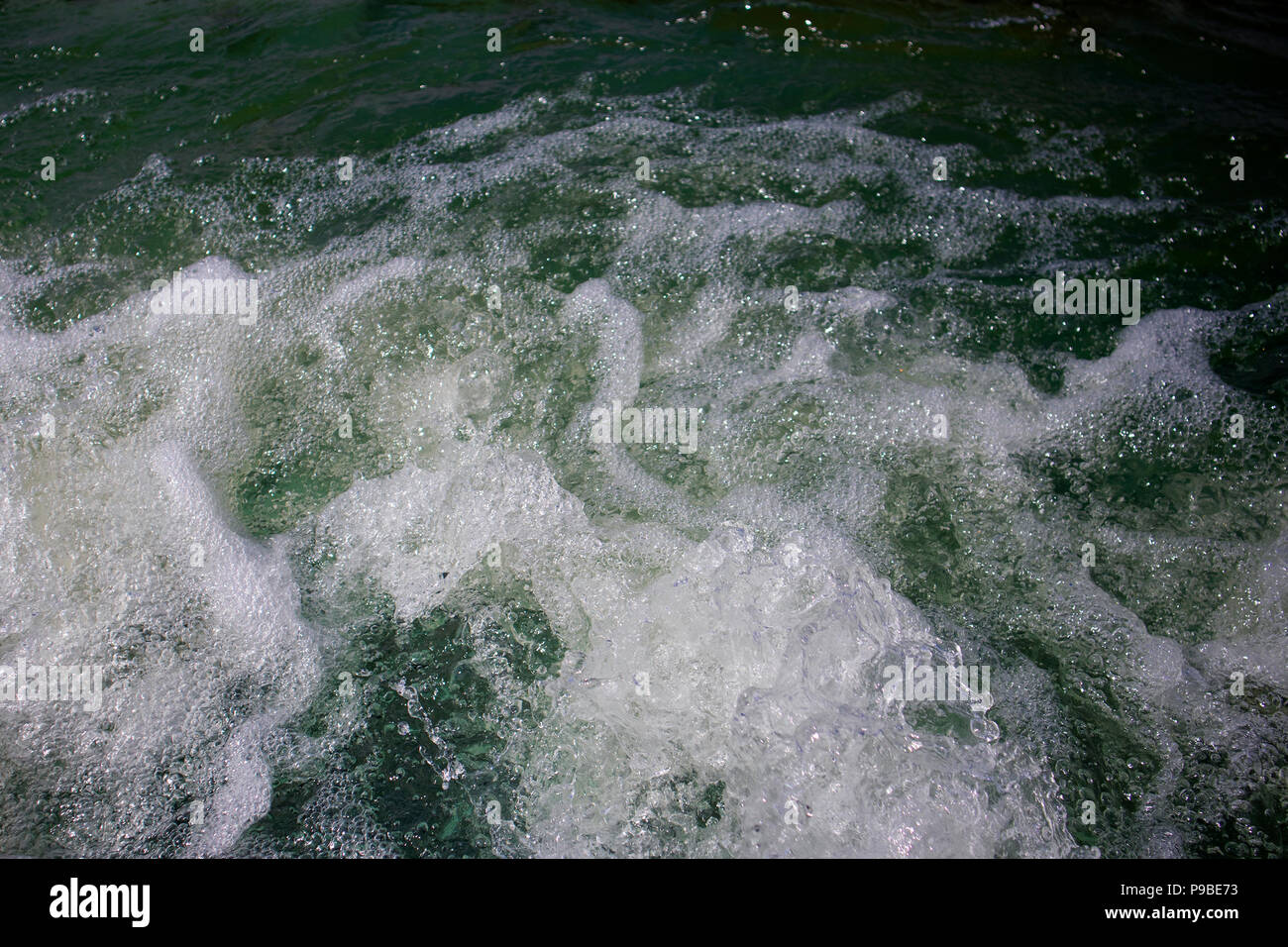 Boiling and foaming bubbled water in a large fountain reservoir Stock ...