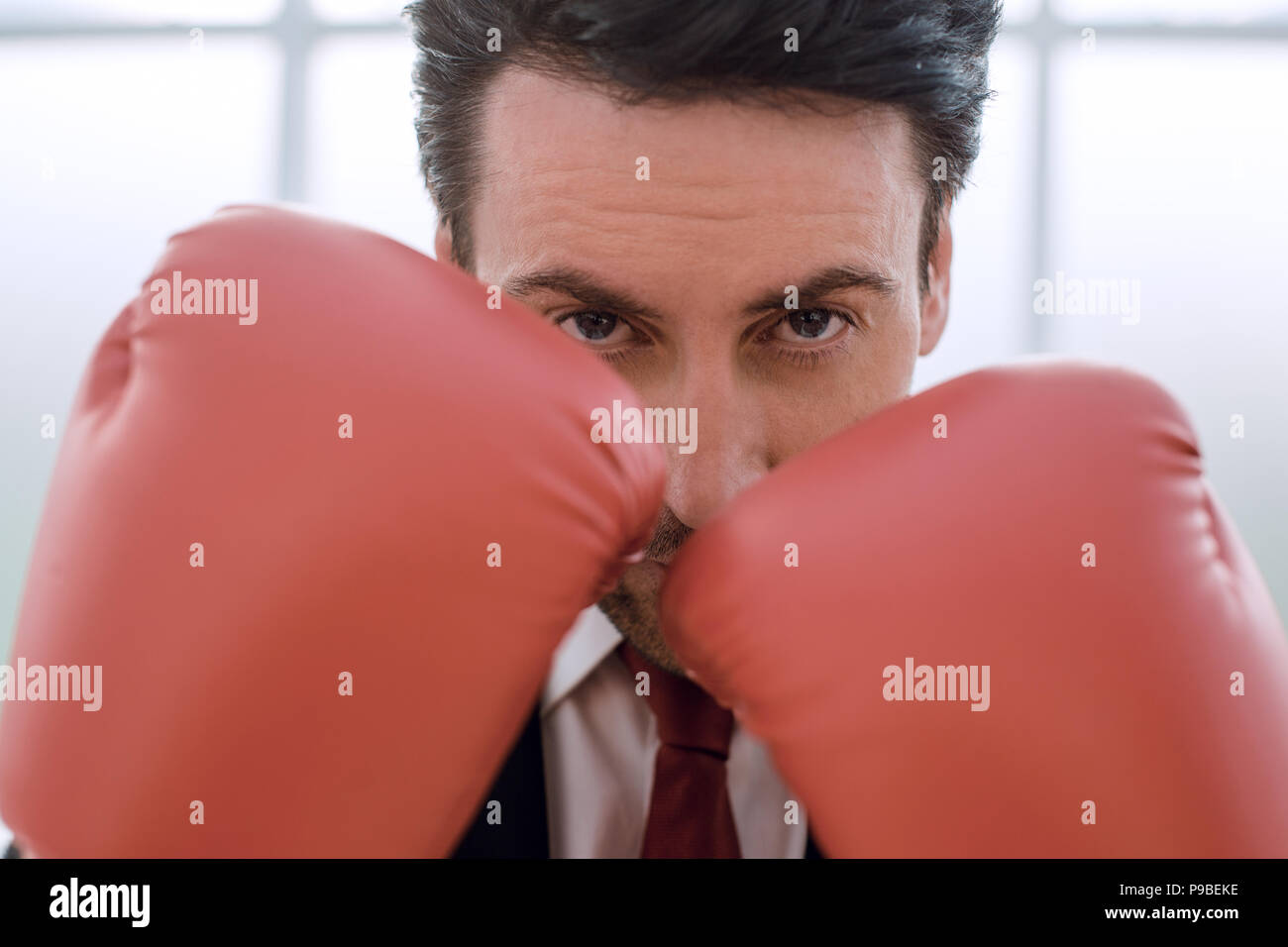 close up.businessman in Boxing gloves holding a punch Stock Photo - Alamy