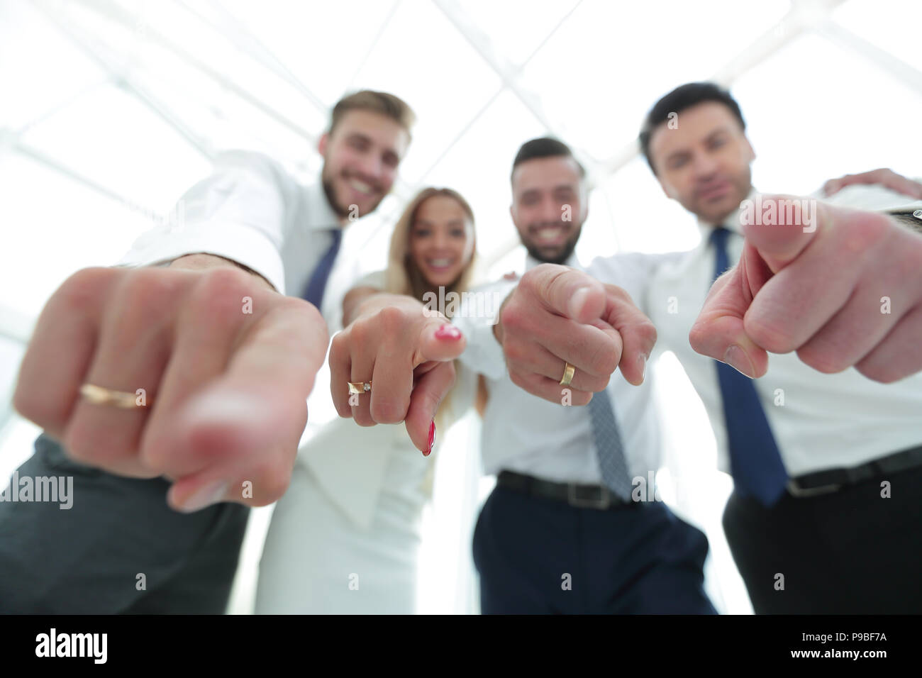 close up.smiling business team showing off at you Stock Photo - Alamy