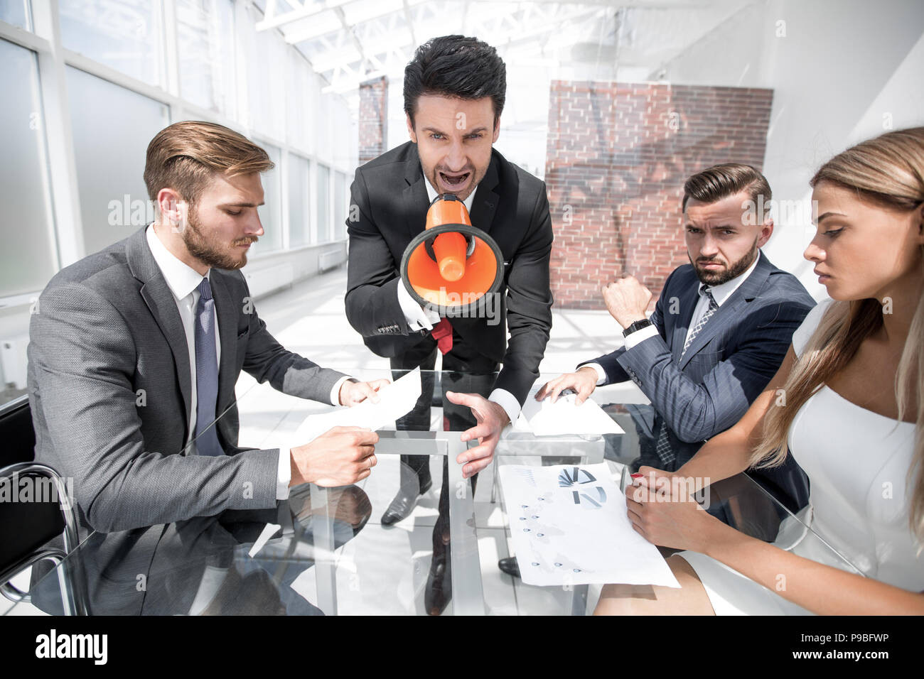 angry Manager with a megaphone at the meeting Stock Photo - Alamy