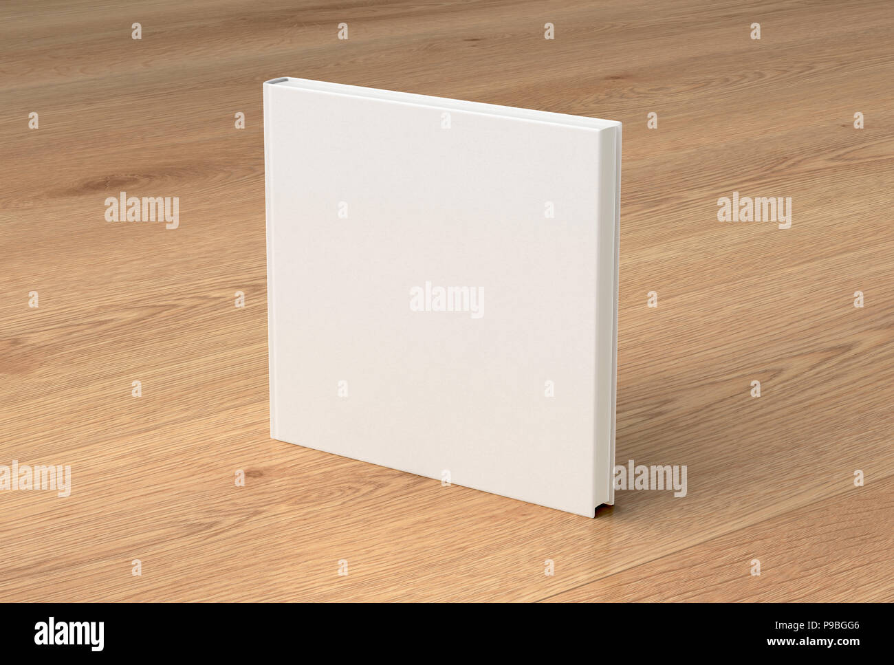 White blank square book cover standing isolated on glossy wooden ...