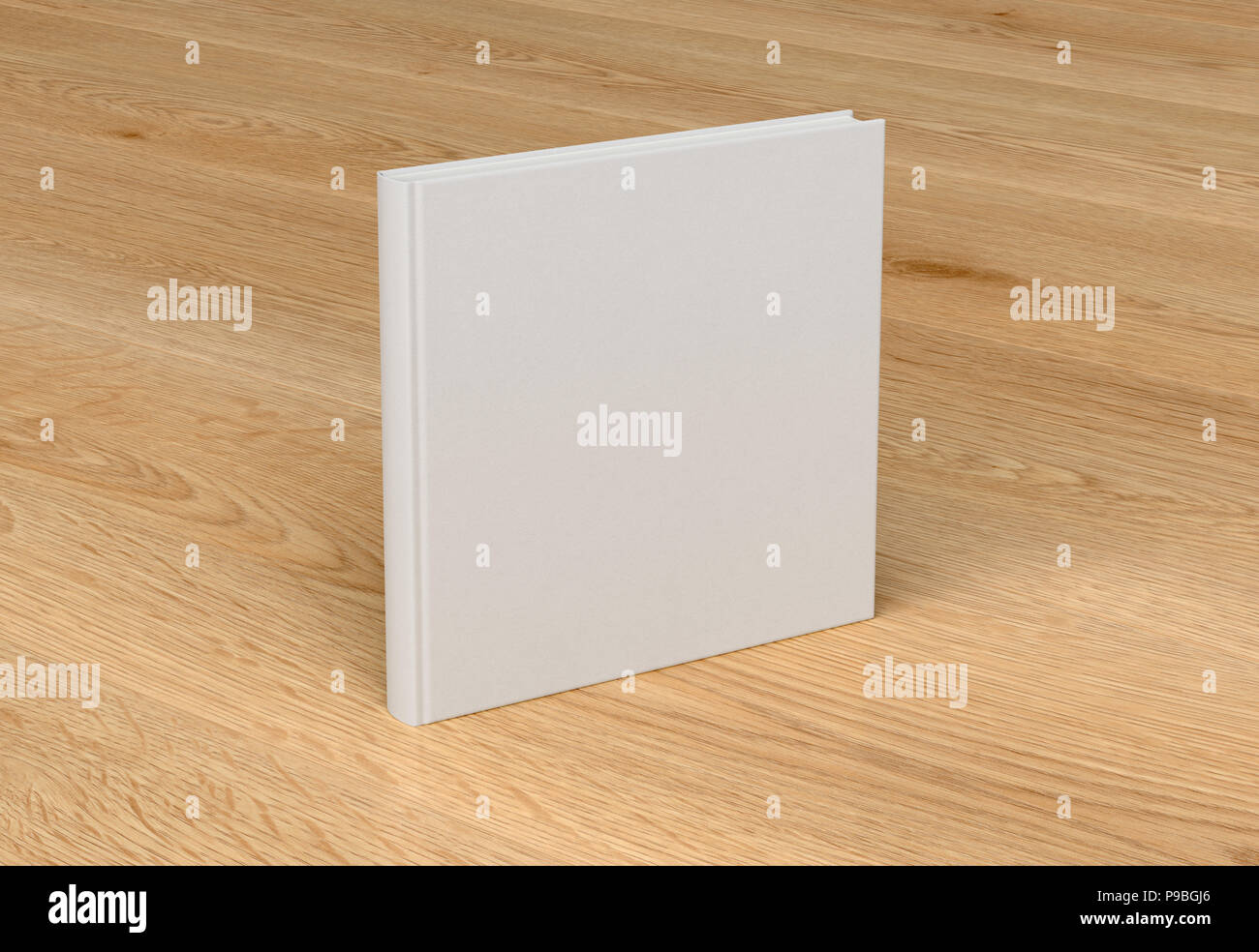 White blank square book cover standing isolated on glossy wooden ...