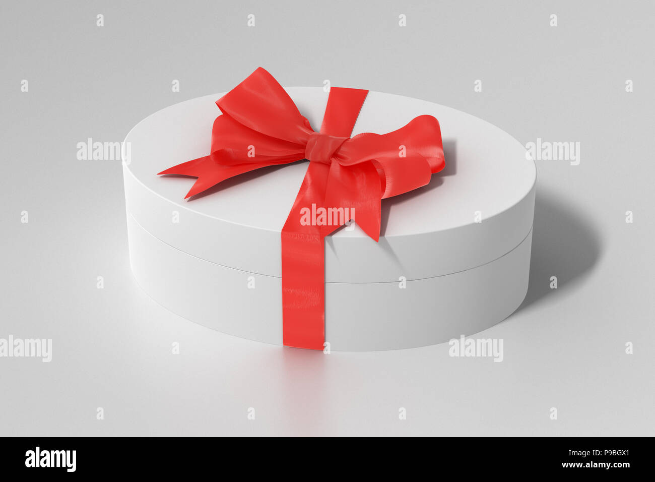 White oval gift box with red bow on white background with clipping path ...