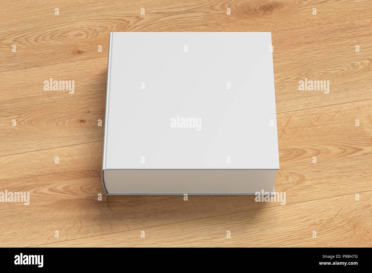 White blank square thick book cover on wooden background with clipping ...