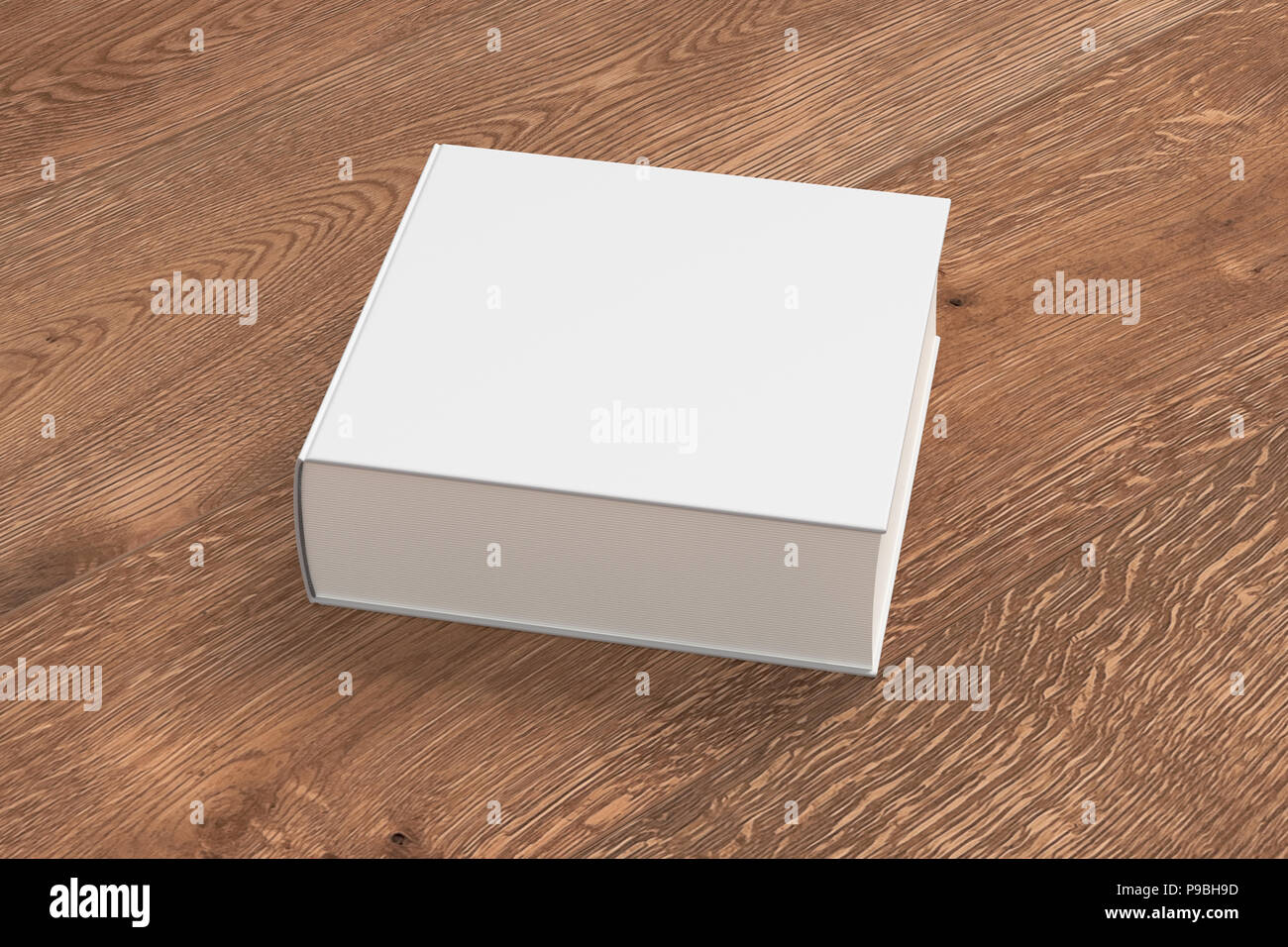 White blank square thick book cover on wooden background with clipping ...